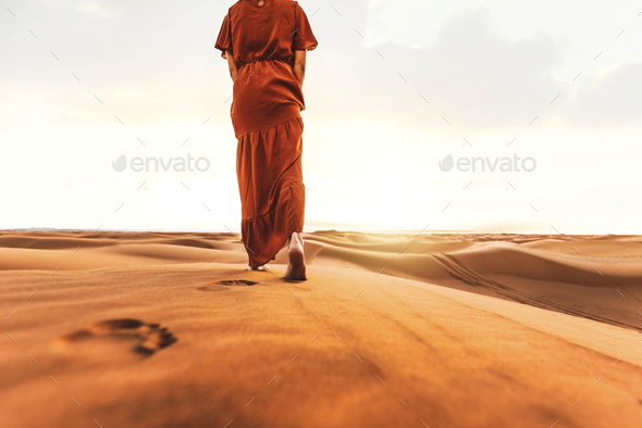 Arabian woman walk in the desert sand dunes at sunset - Wanderlust and ...