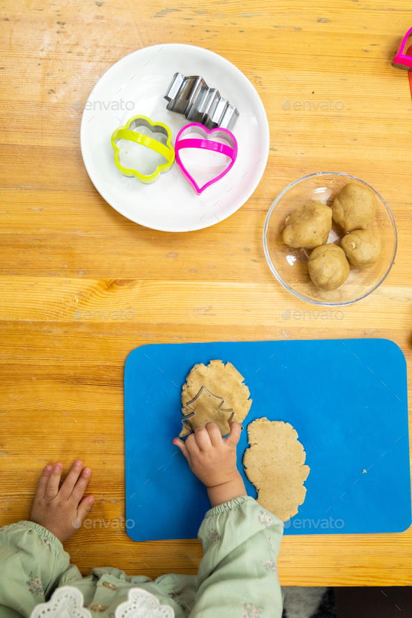 Toddler making shapes with play dough using rolling pin Stock Photo by ...
