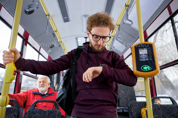 Young busy men with watch hurrying to work by bus Stock Photo by ...