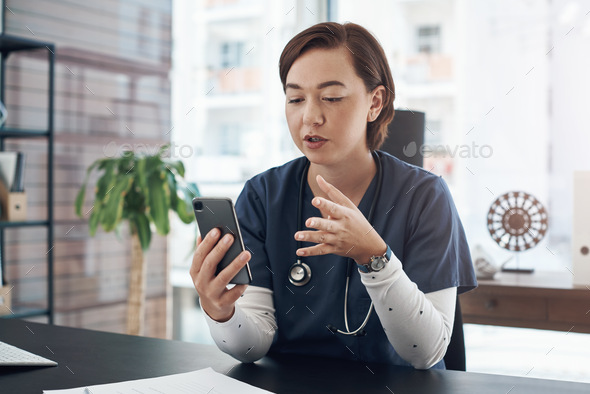 Shot of a young doctor using a cellphone in an office Stock Photo by ...