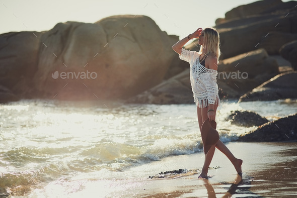 The best therapy is beach therapy. Shot of a beautiful young woman ...