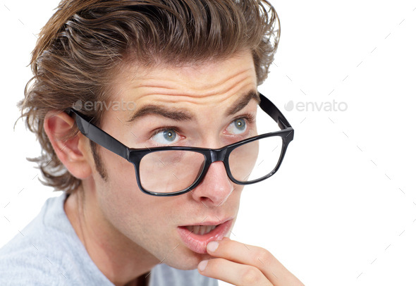 Looking pensive. Young man wearing glasses touching his lip and looking ...