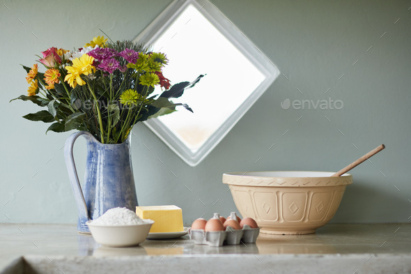Shot of a counter with baking ingredients arranged on it in a country ...