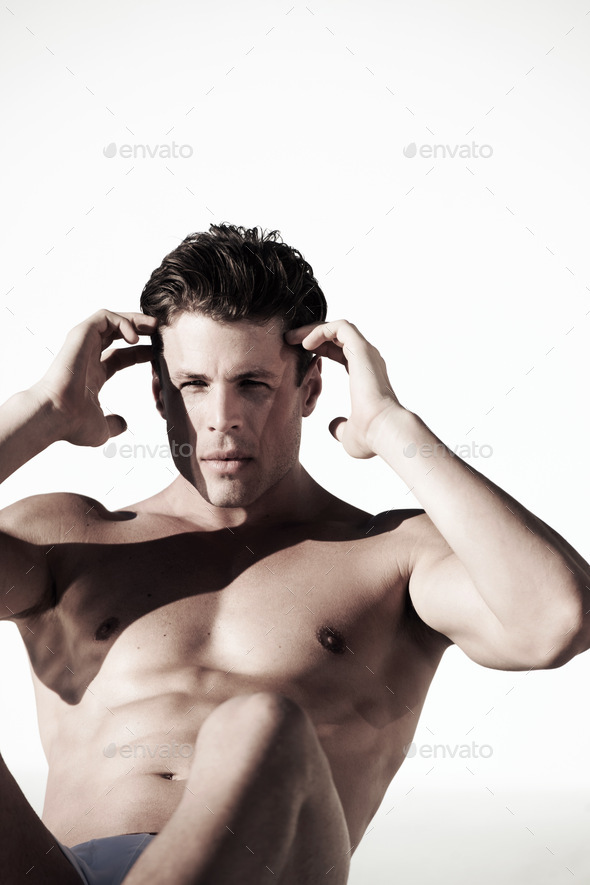 Keeping my body in shape. A muscular male doing sit ups. Stock Photo by ...