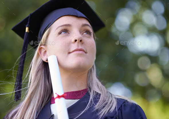 Thinking of her future. A female graduate holding her diploma. Stock ...