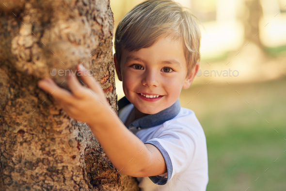 Hide and seek level expert. Shot of a happy little boy playing next to ...