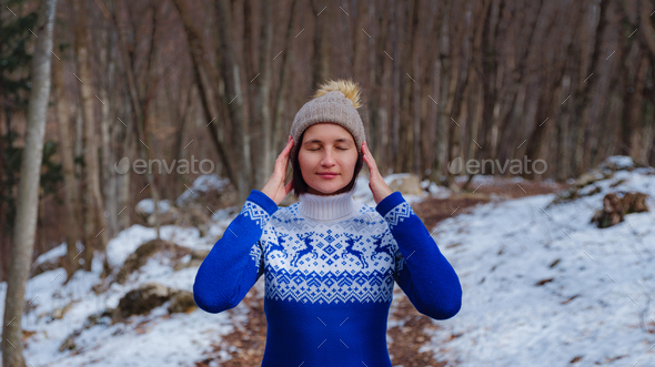 Beautiful woman standing among trees in winter forest Stock Photo by ...