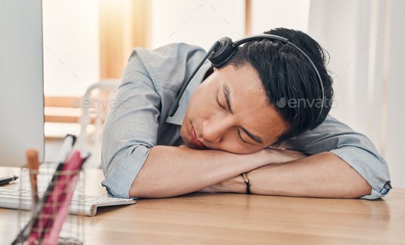 Man, sleeping and desk at work in call center, communication or ...