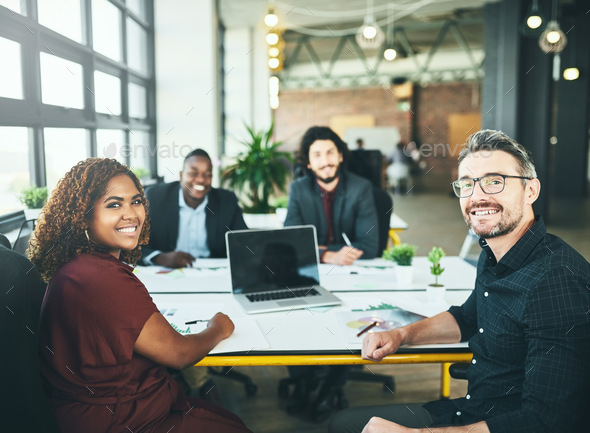 Cropped portrait of a group of colleagues working around a desk in ...
