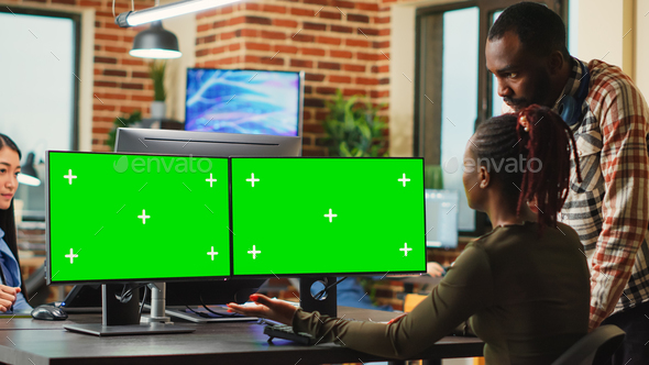 Digital company employees using greenscreen display on computers Stock ...