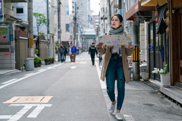 lady exploring with map in osaka japan Stock Photo by primagefactory