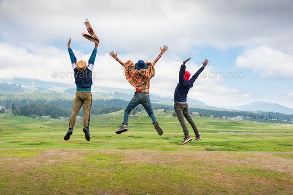 Three young man jumping on meadow Stock Photo by wirestock | PhotoDune