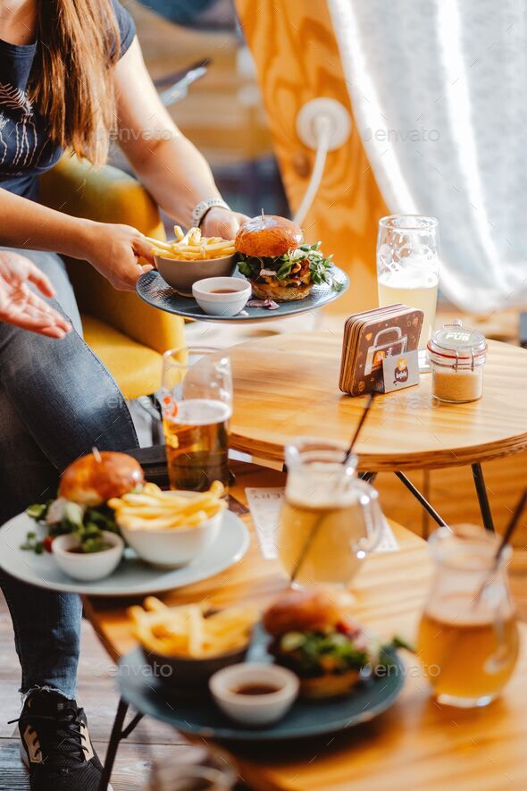 Vertical shot of a gourmet fast food restaurant table with burgers ...