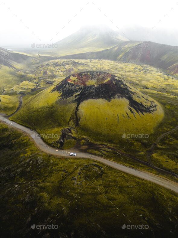 Aerial view of Laki volcano surrounded by greenery hills with road in ...