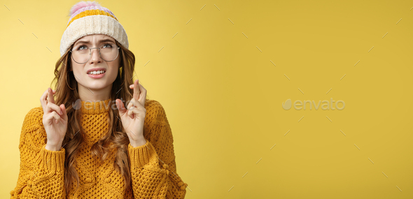 Worried cute girl nerd hope pass exam standing nervous cross fingers ...