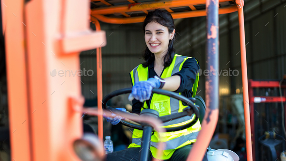 women worker at forklift driver happy working in industry factory ...