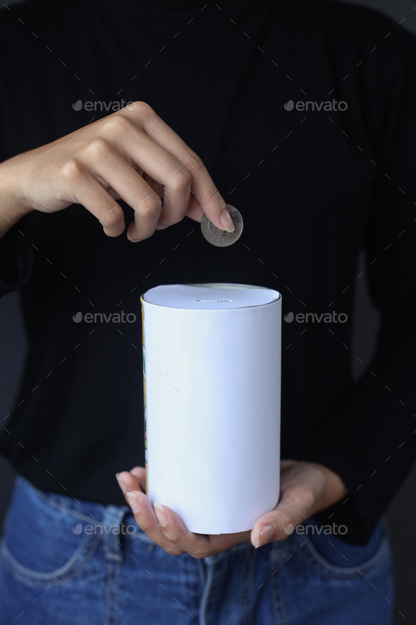 Inserting coin in donation can for mock up Stock Photo by Queenmoonlite