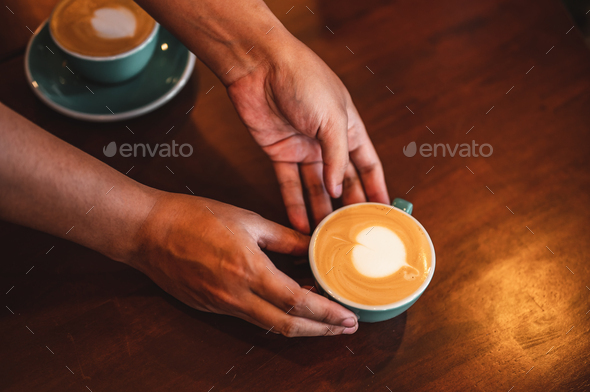 Close up of hands barista man serving coffee in coffee shop. male hands ...