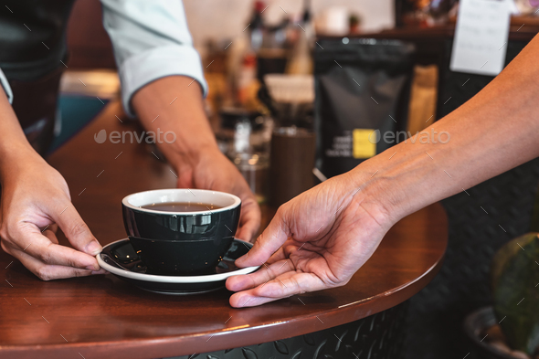 Close up of hands barista man serving coffee in coffee shop. male hands ...