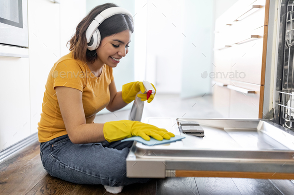 Smiling Middle Eastern Female Wiping Washing Machine Surface While ...