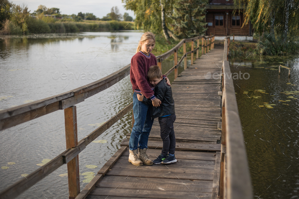 Upset young mother give comforting hug to crying little son. dad and ...