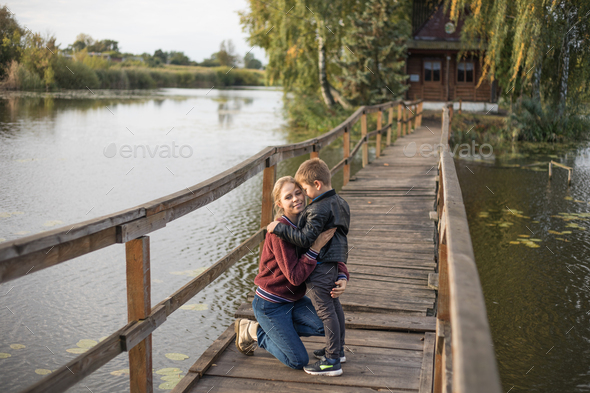Upset young mother give comforting hug to crying little son. dad and ...