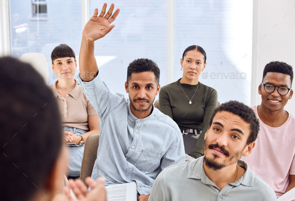 Shot of a young businessman raising his hand during a presentation in ...