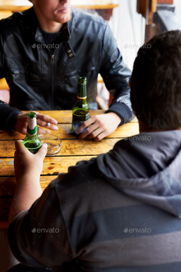 Cold beers and good times. Cropped image of two young men drinking ...