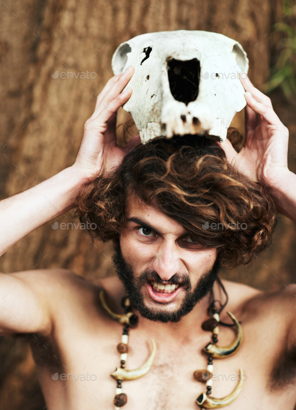 Crowning himself King of the Jungle. An aggressive caveman placing an ...