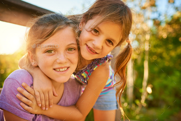 Friends and siblings for life. Portrait of two little girls playing ...