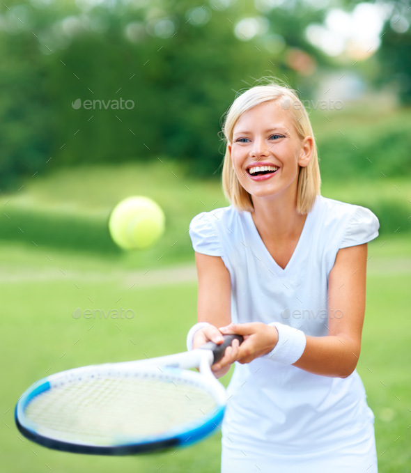 Just for fun. A young female tennis player bouncing the ball on her ...
