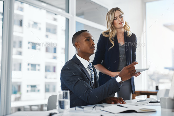 Teamwork makes success happen. Shot of two businesspeople working ...