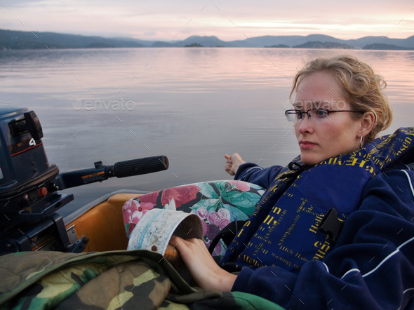 A real-life image of a beautiful young woman relaxing in a boat on a ...