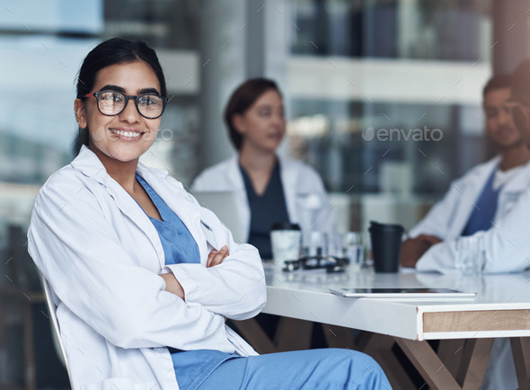 Shot of a female doctor sitting down to take a break from her work ...
