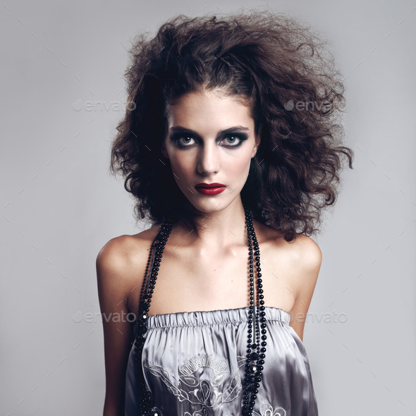 Studio portrait of a beautiful young fashion model standing against a ...