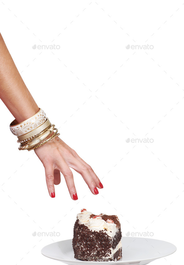 Reaching for her delicious prize. Cropped image of a womans hand ...