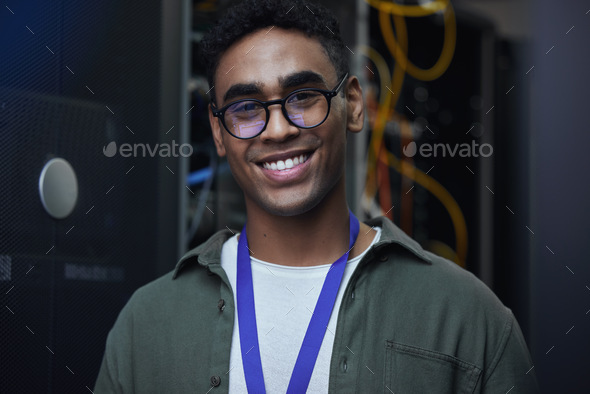 Cropped portrait of a handsome male IT support agent working in a dark ...