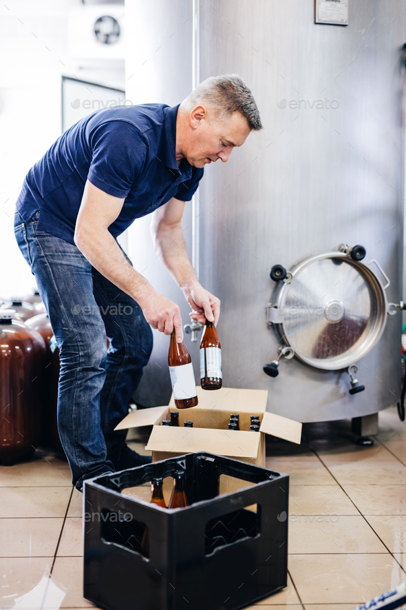Man preparing craft beer from brewery for shipment. Stock Photo by ...