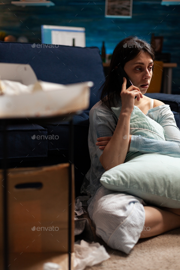 Depressed person with mental health problems talking on phone call ...