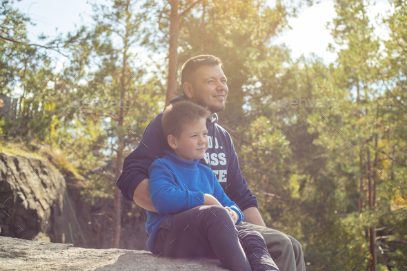 Father hug his son enjoying the time, happy child toothy smiling.Parent ...