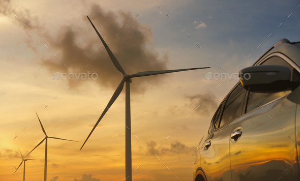 Close-up car in with wind turbines and sunset backgrounds. Stock Photo ...