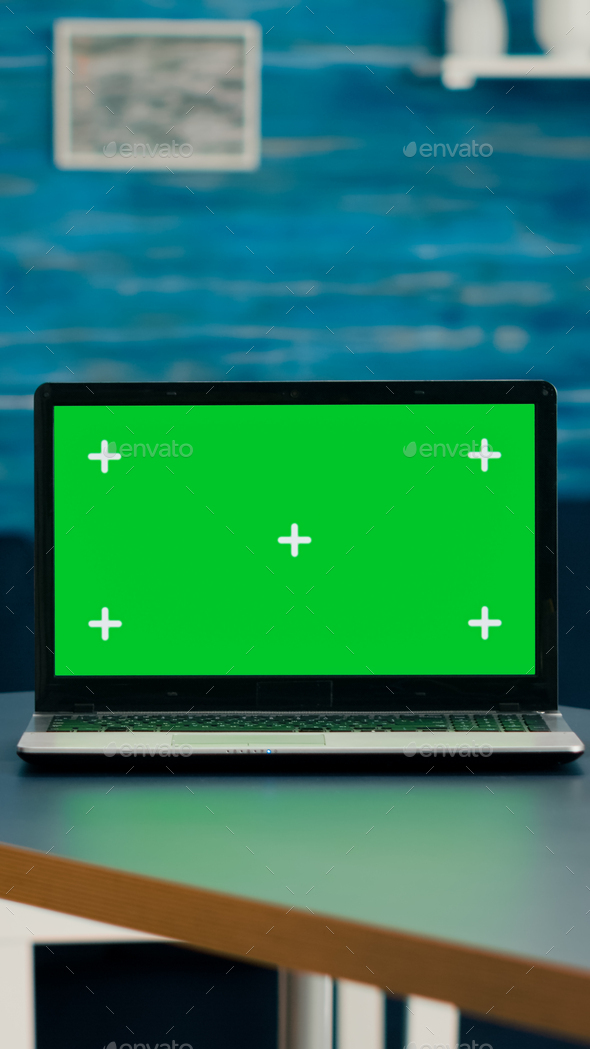 Laptop computer with mock up green screen chroma key standing on desk ...