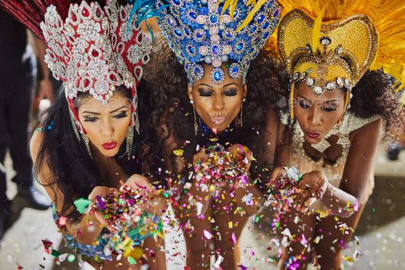 Shot of samba dancers blowing confetti from their hands while ...