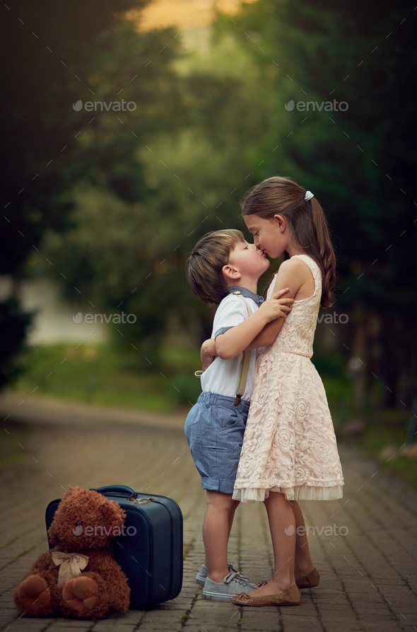 Shot of a cute little girl kissing her little brother while they play outside Stock Photo by ...