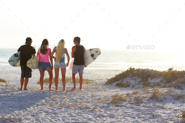 The perfect wave is coming. Shot of surfing friends at the beach. Stock ...