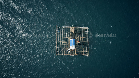 High angle shot of a built fishing structure floating in the middle of ...