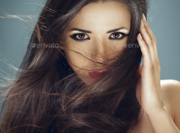 Wild beauty. Studio portrait of a fashion model with wind swept hair ...