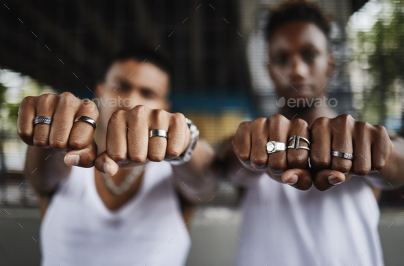 Closeup shot of two male gangsters hands showing off their rings with ...
