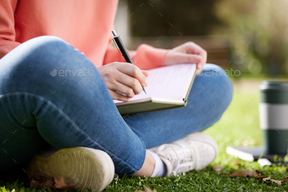 Im passionate about writing. Shot of a student writing in her notebook ...