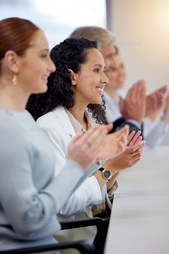 Shot of a group of businesspeople clapping hands while in a meeting at ...